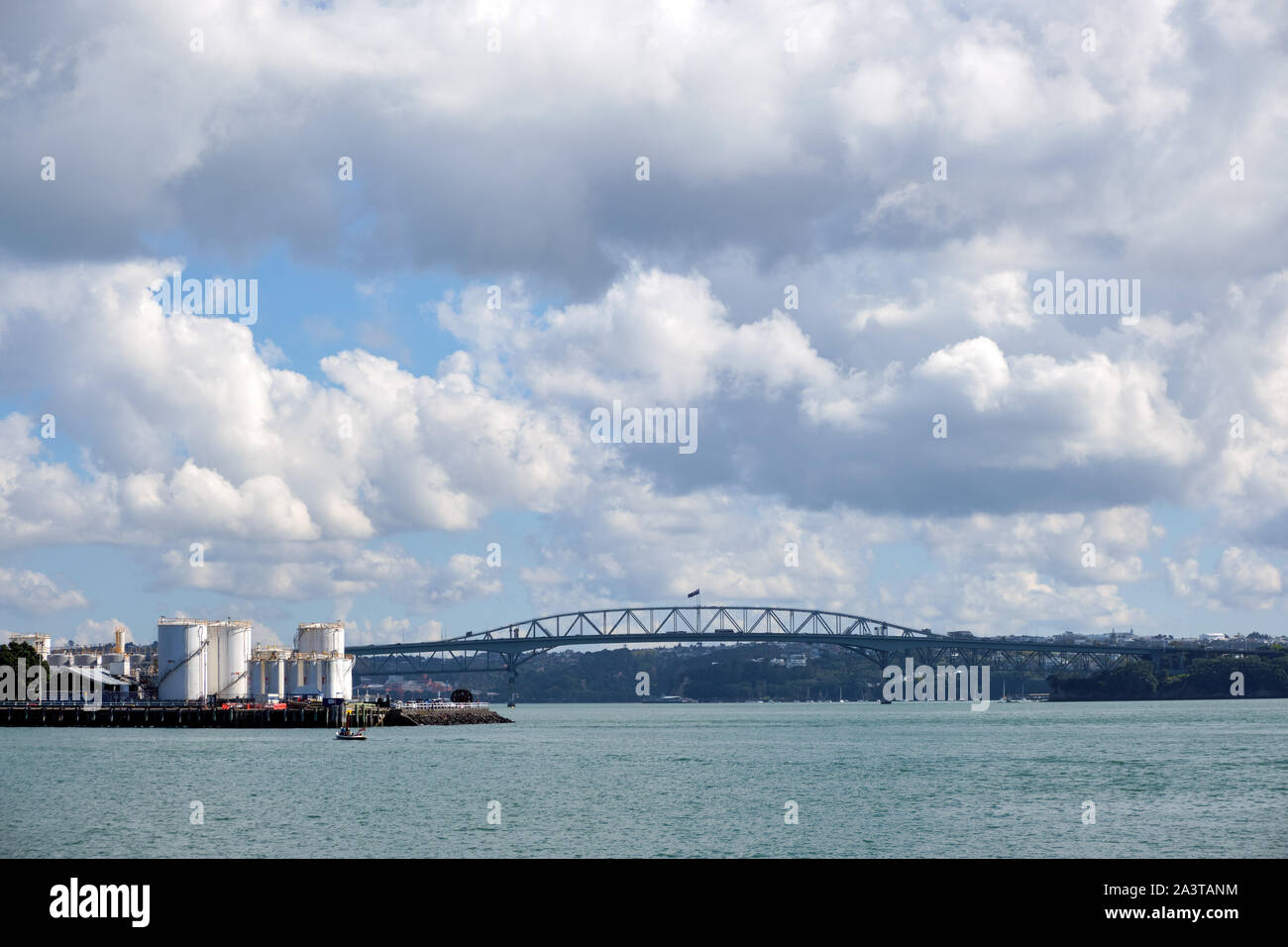 View on the Auckland Harbor bridge with silos and the Big Wheel in the ...