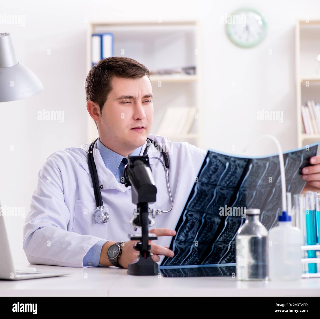 The male doctor looking at lab results in hospital Stock Photo - Alamy