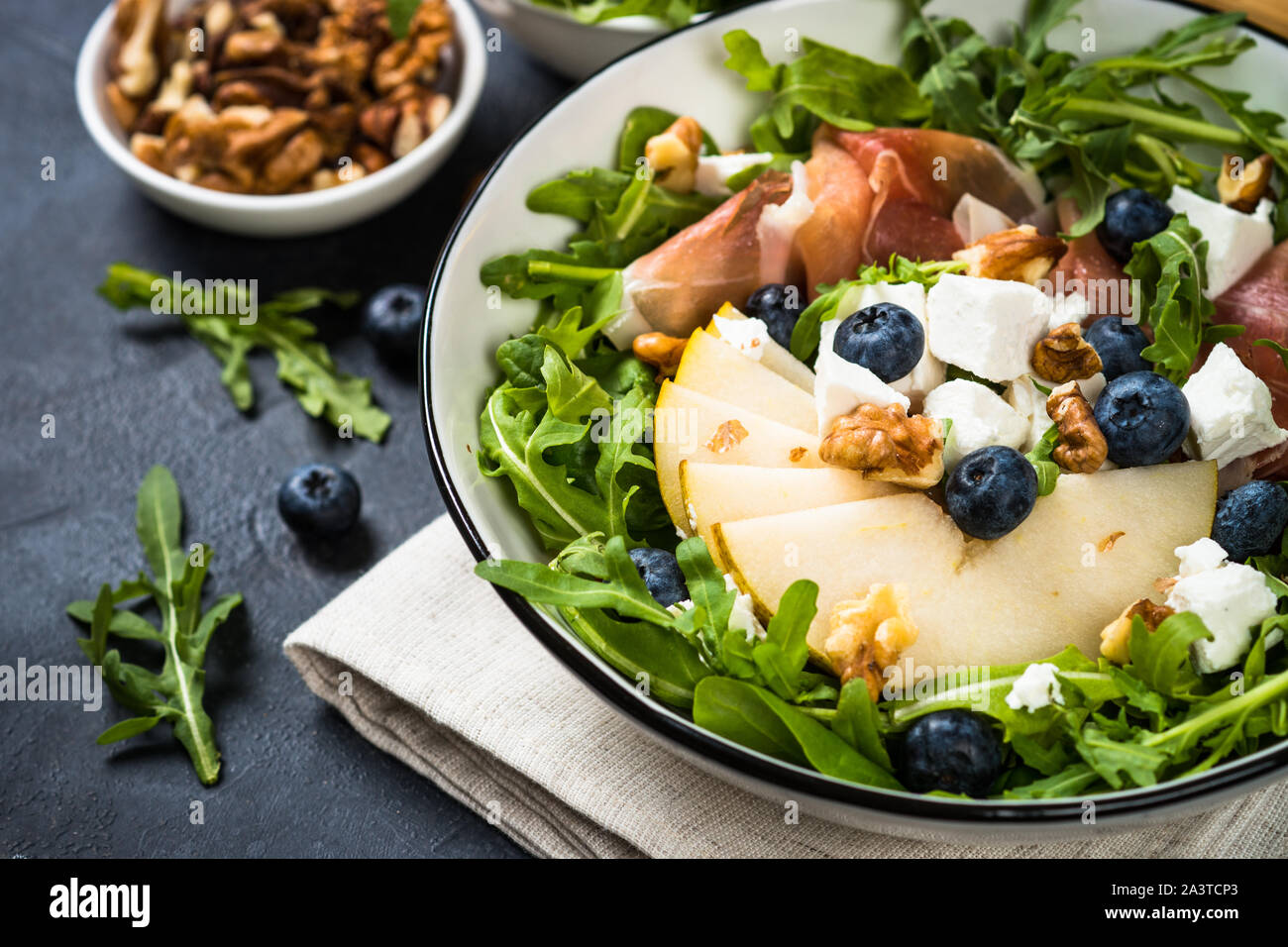 Green salad with leaves, fruit and jamon Stock Photo - Alamy