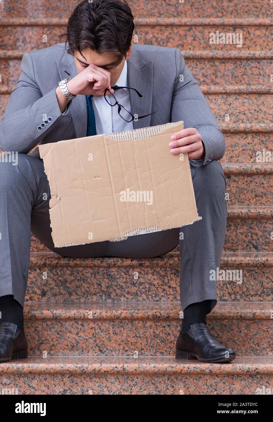 Desperate businessman begging on the street Stock Photo - Alamy