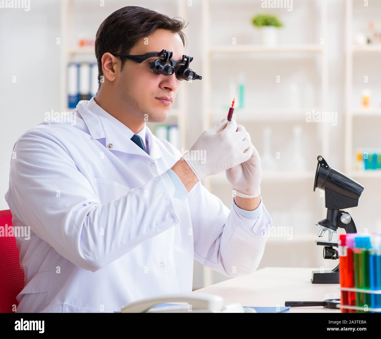 The doctor chemist working on blood samples in lab Stock Photo - Alamy