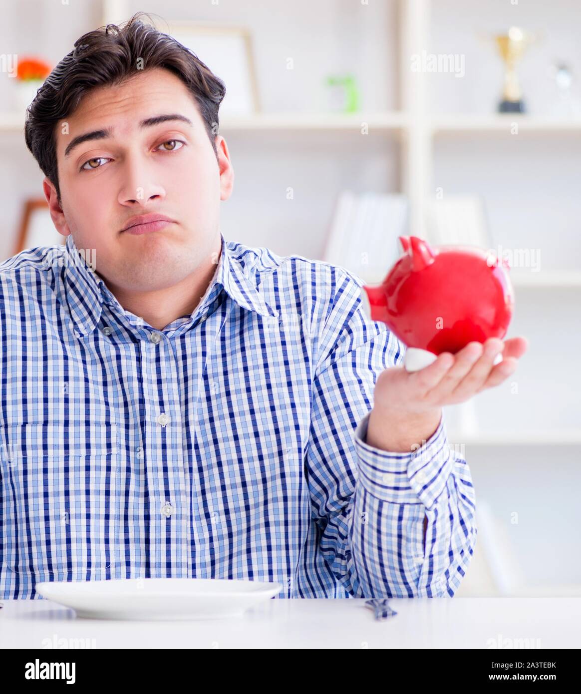 Man running out of money in restaurant and using savings from piggy ...