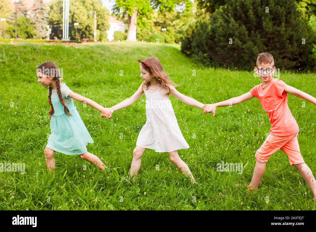 Group of children play on the green grass Stock Photo - Alamy