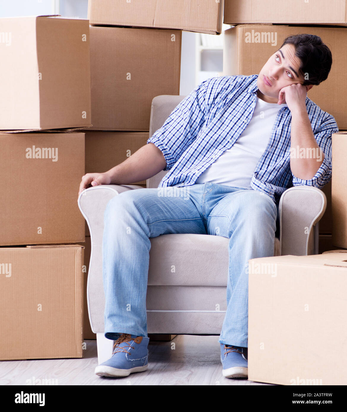 The young man moving in to new house with boxes Stock Photo - Alamy