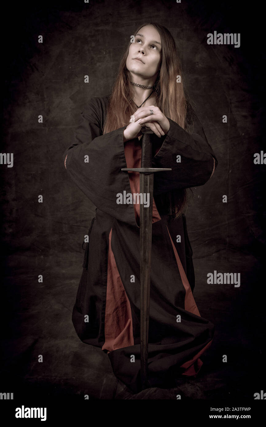 full length portrait of young long haired woman wearing a medieval ...