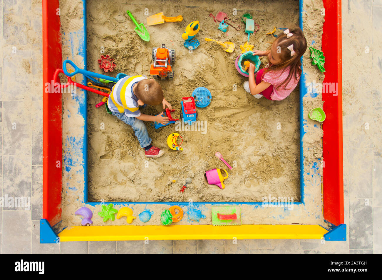Kids having fun in big modern sandbox outside Stock Photo - Alamy