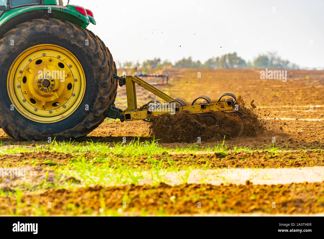 rural landscape, tractor cultivates agricultural land Stock Photo - Alamy