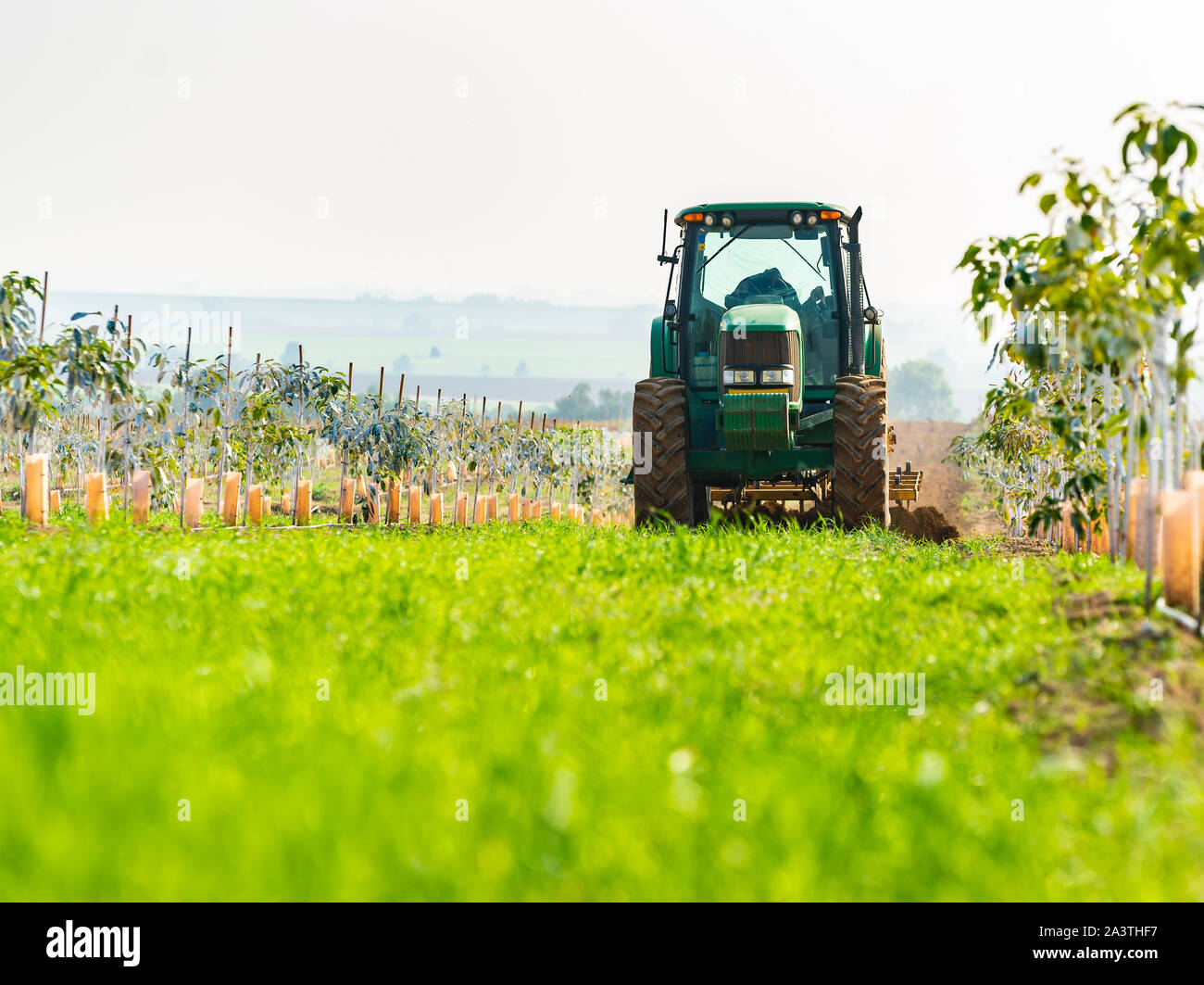 rural landscape, tractor cultivates agricultural land Stock Photo - Alamy