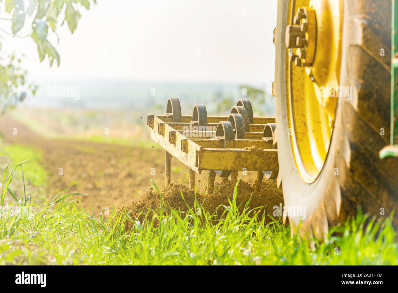 rural landscape, tractor cultivates agricultural land Stock Photo - Alamy