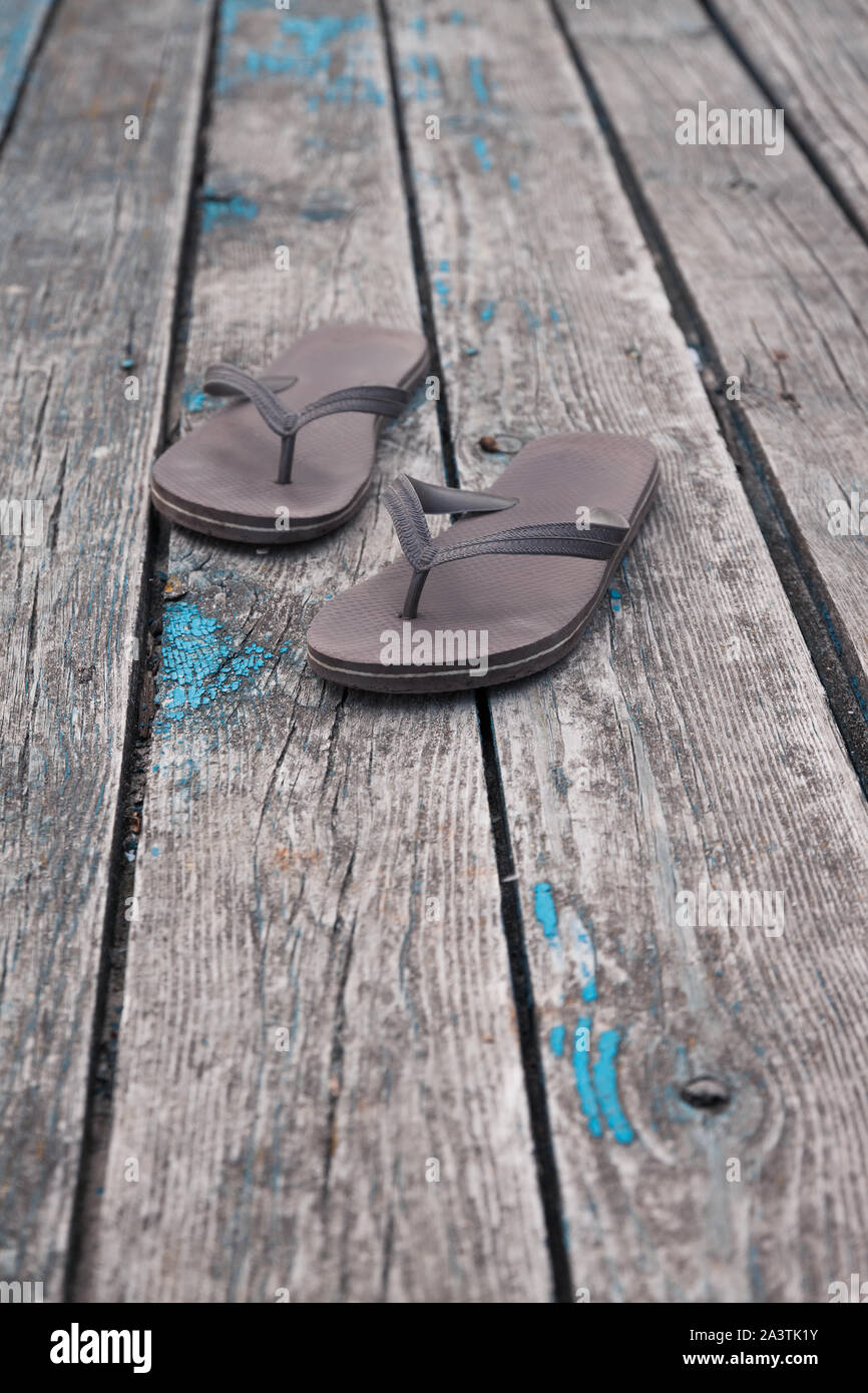 brown flip flops slippers on old wooden deck mooring background Stock ...