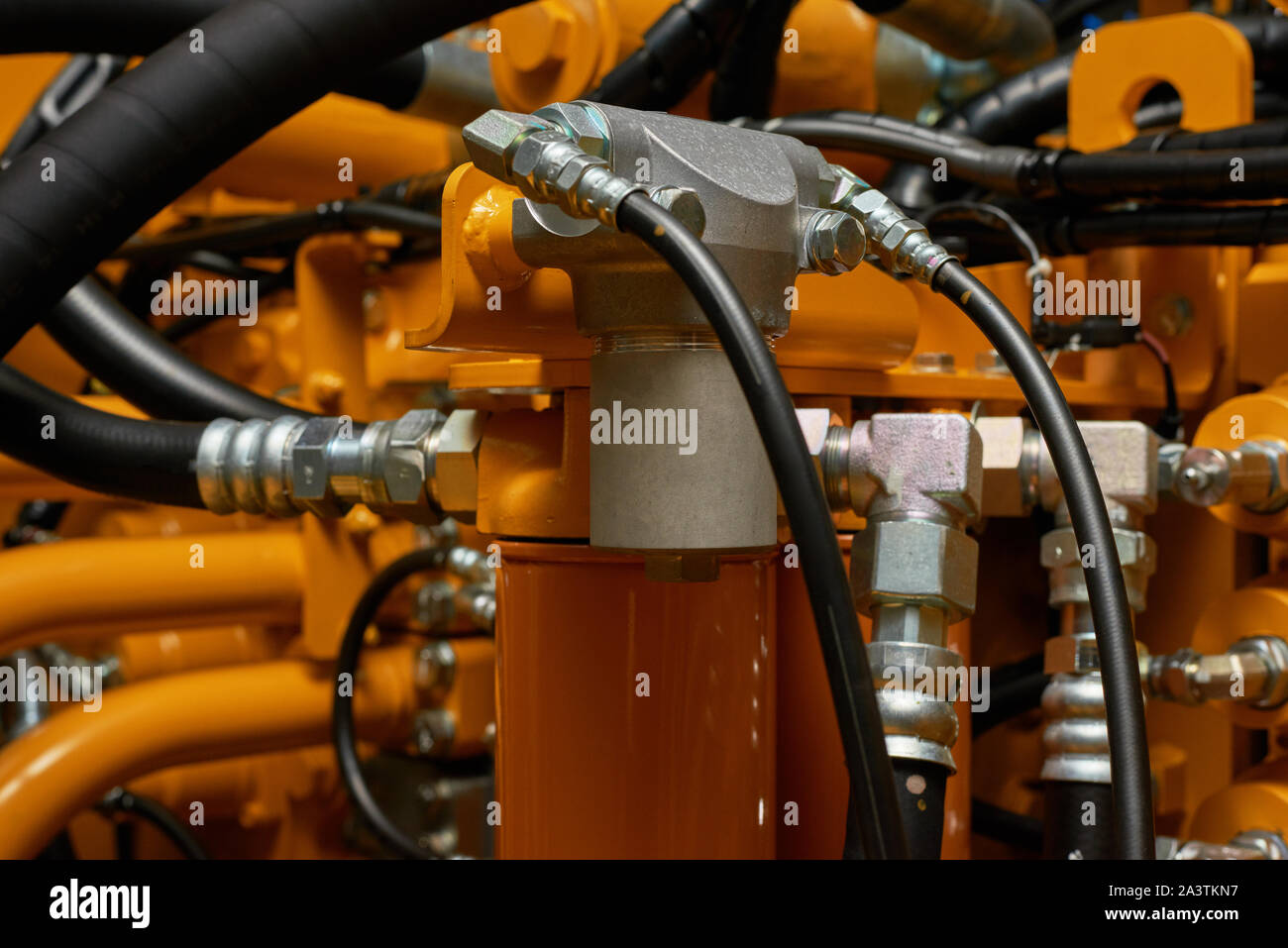 Close up view of hydraulic pipes of heavy industry machine. Low key ...