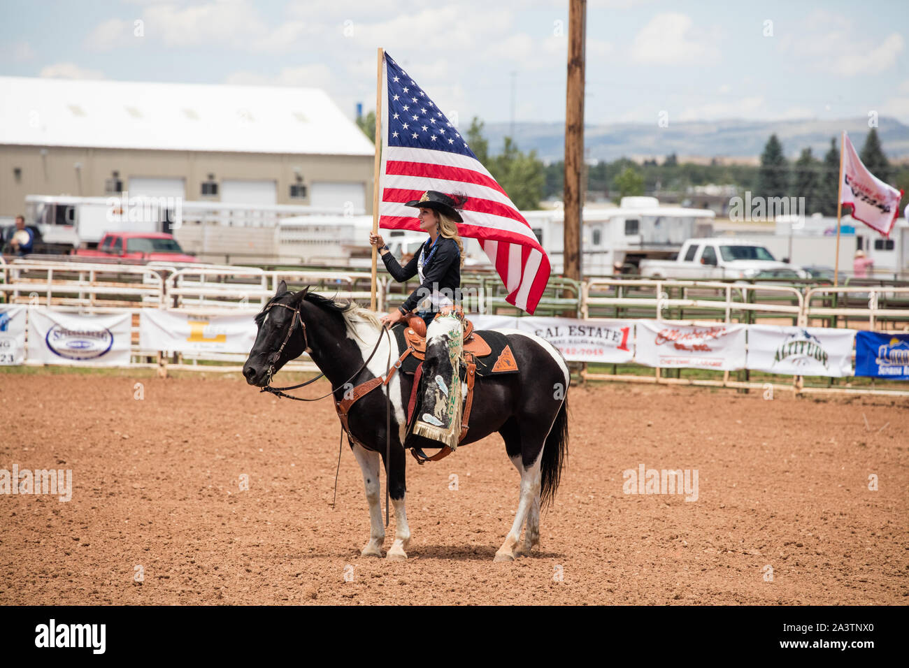 The American flag-bearer at a large outdoor rodeo that's a feature of ...
