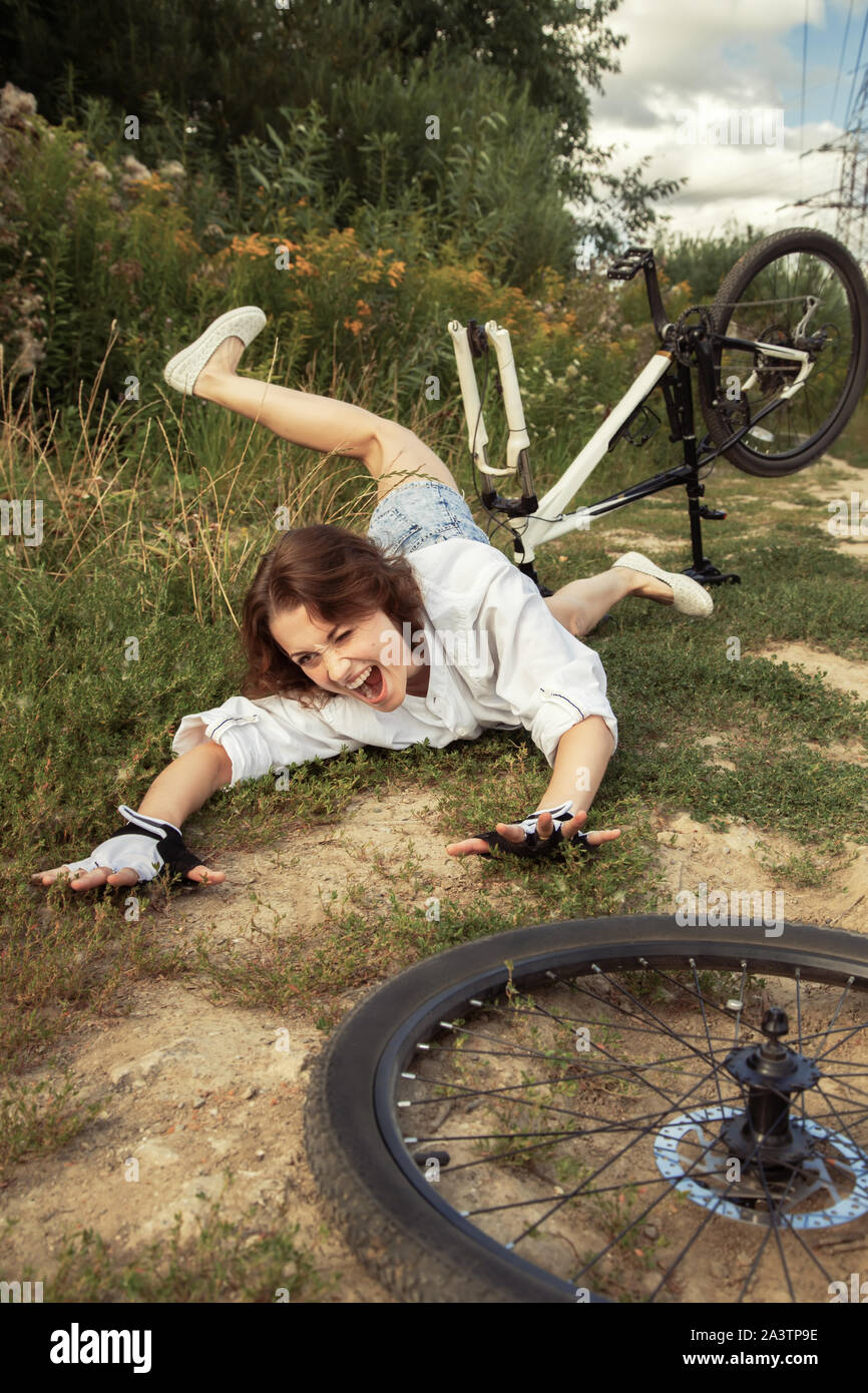 girl fell from the bicycle, lies on asphalt shouts Stock Photo - Alamy