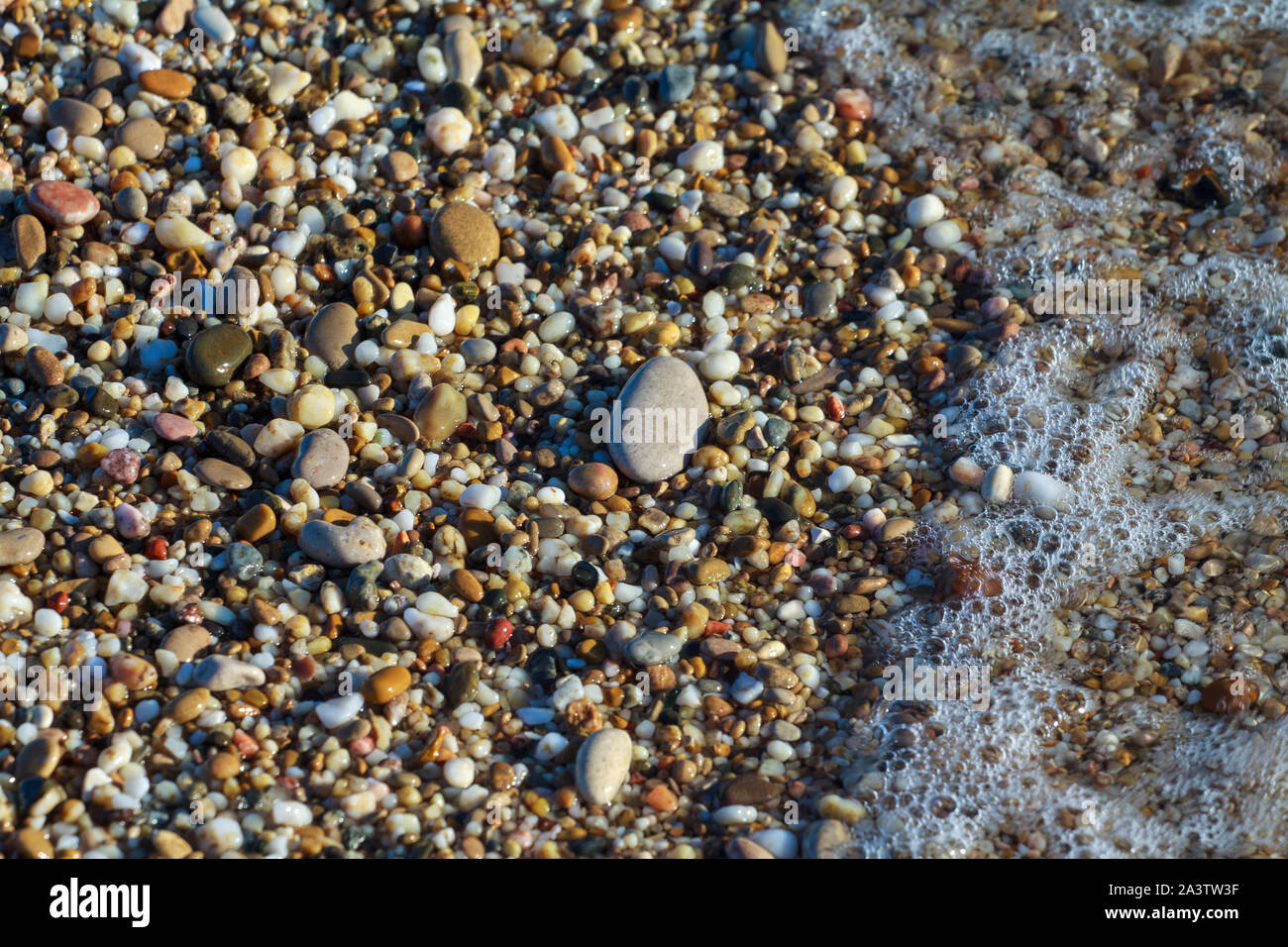 sea pebbles colored granite on the beach background stones. The shore ...