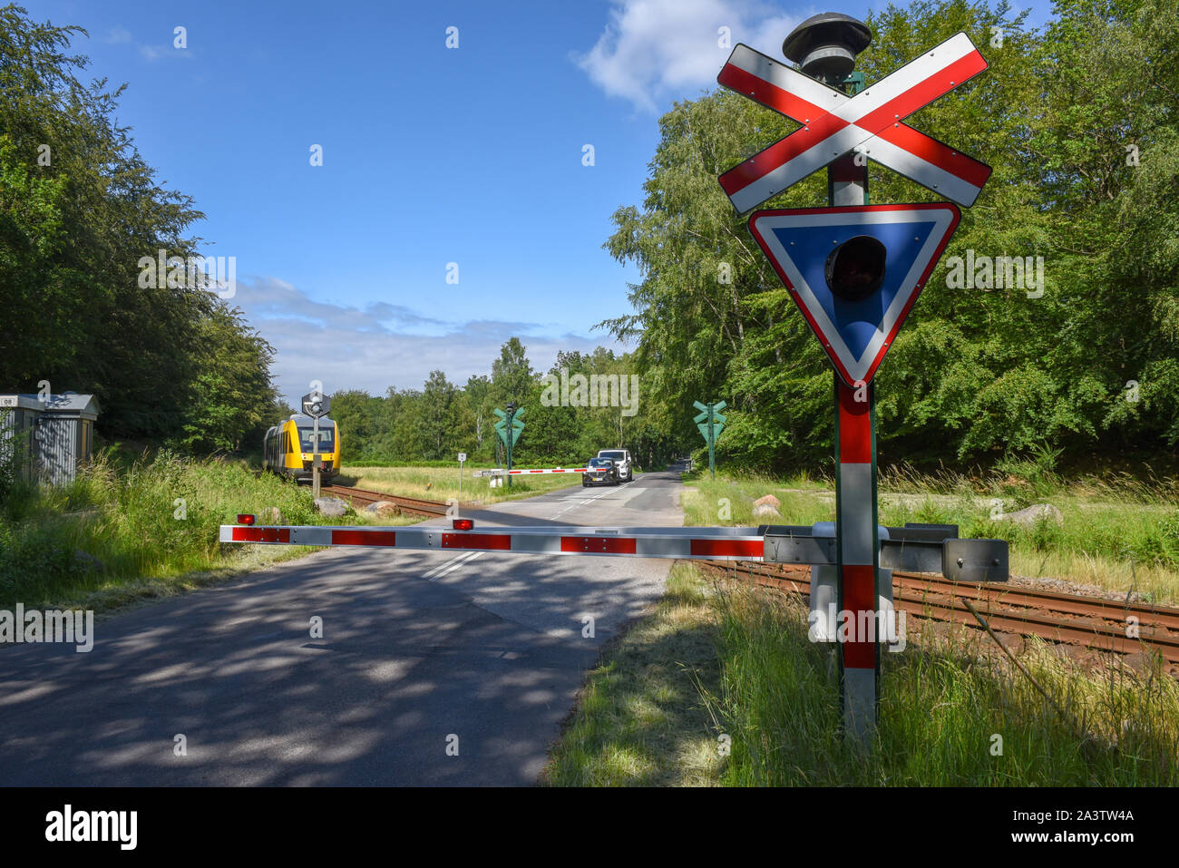 Railroad crossing gate on the forest at Gribskov in Denmark Stock Photo ...