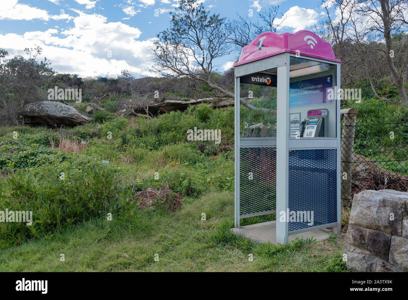 A pink topped Telstra public phone booth in a bush setting on Dee Why ...