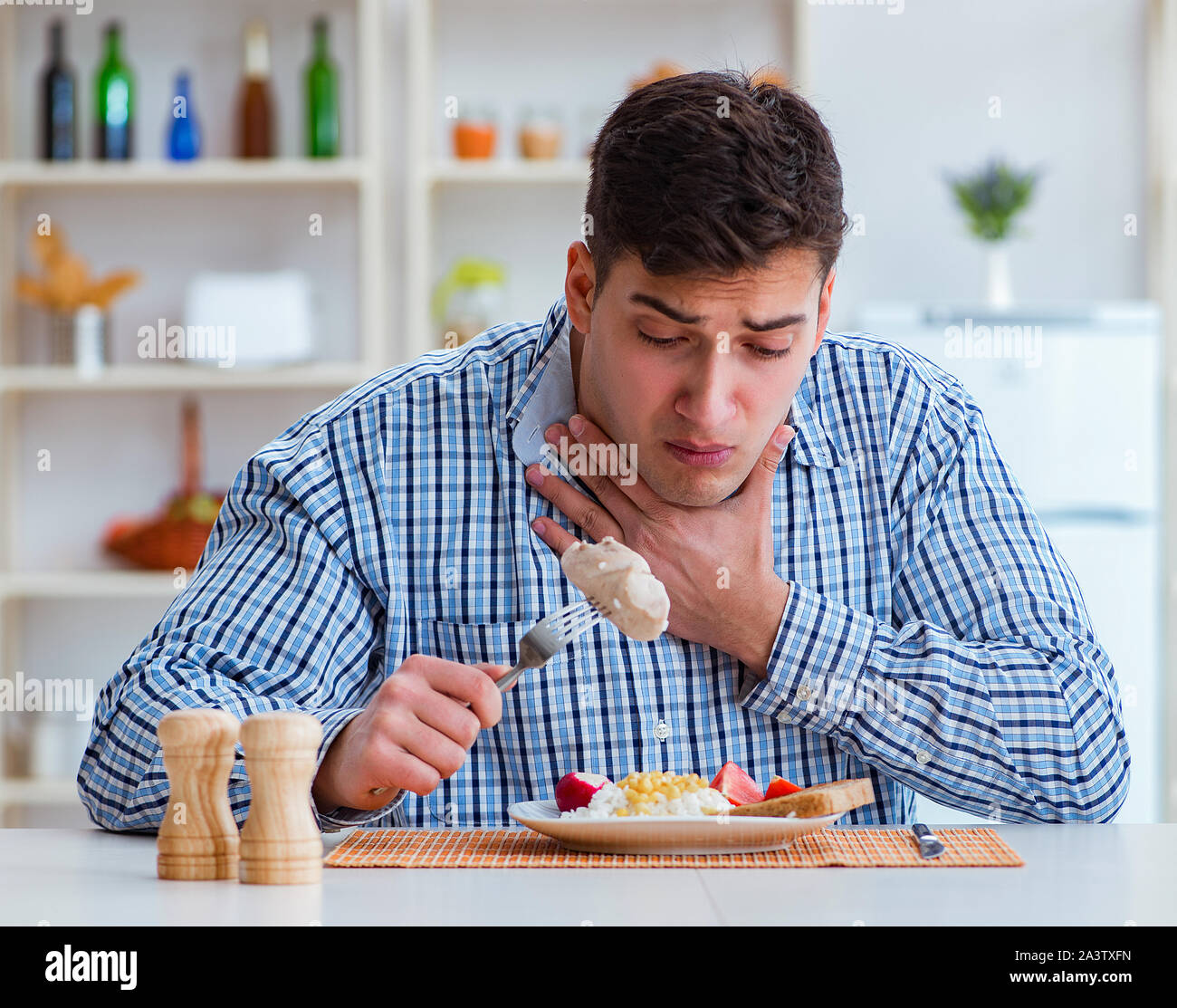 The man eating tasteless food at home for lunch Stock Photo - Alamy