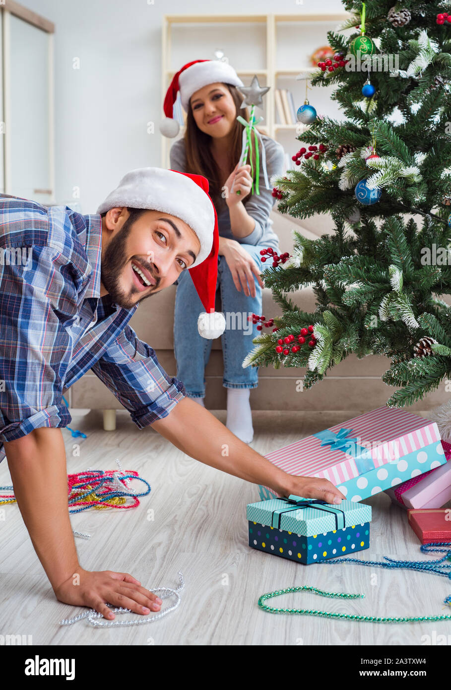 The girlfriend and boyfriend opening christmas gifts Stock Photo - Alamy