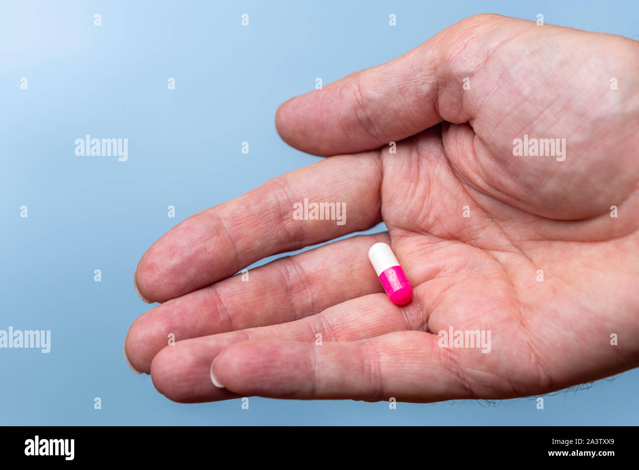 Red hand holding pill hi-res stock photography and images - Alamy