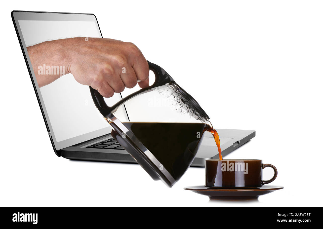 laptop with man's hand holding and pouring coffee Stock Photo - Alamy