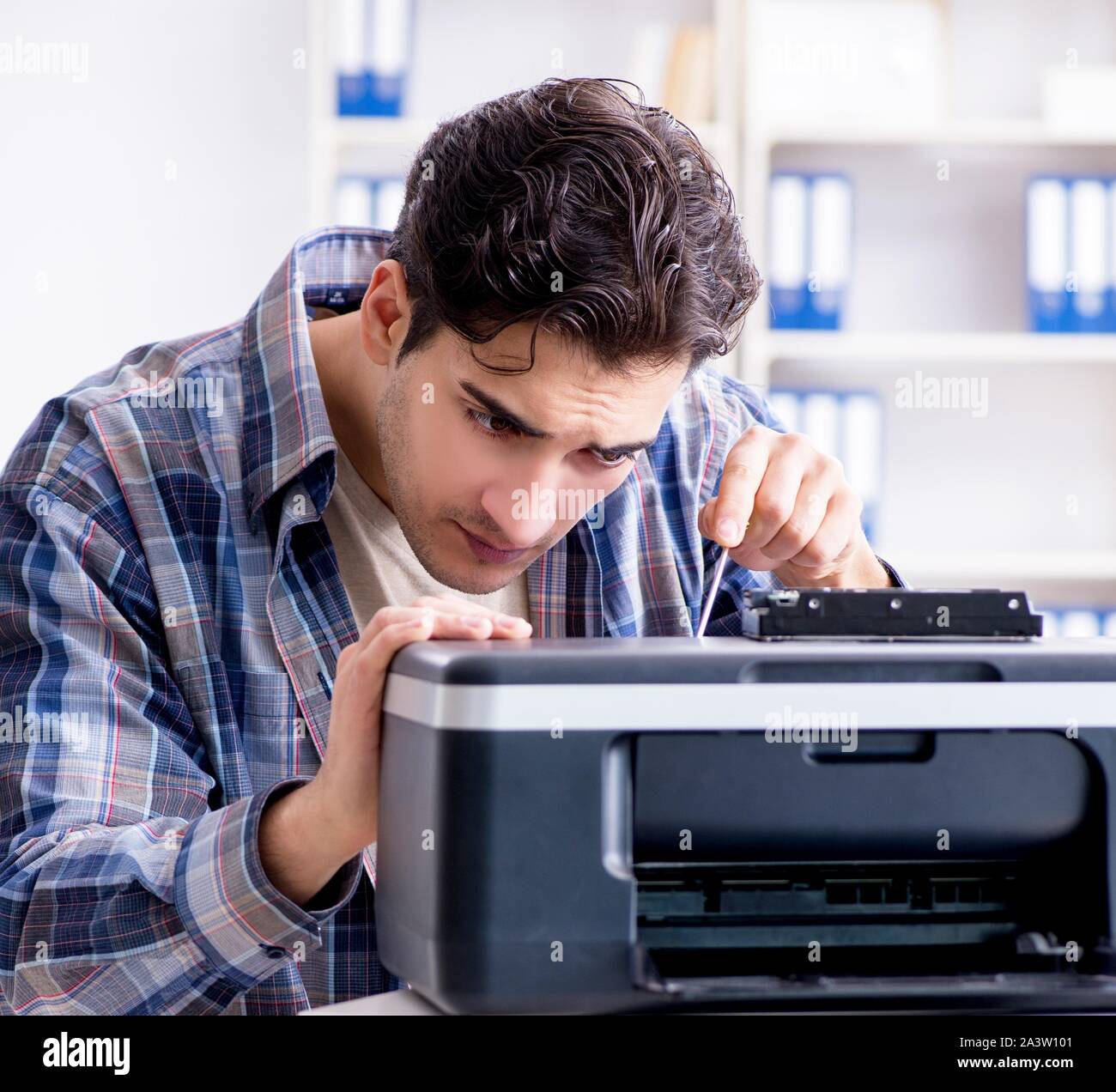 The hardware repairman repairing broken printer fax machine Stock Photo ...