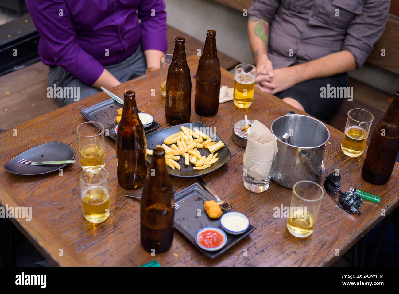Beer and snacks on table where men are having fun Stock Photo - Alamy