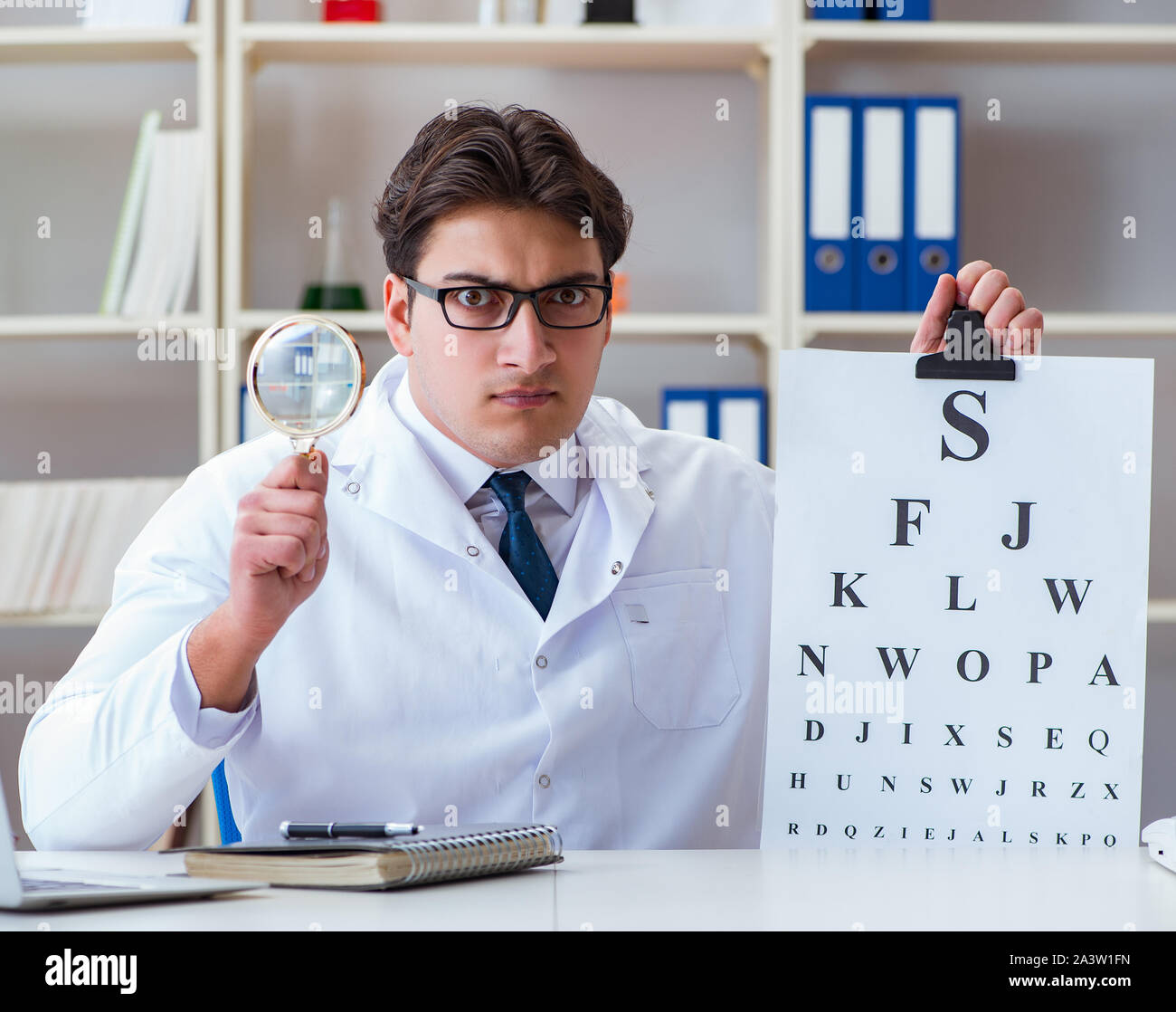 The doctor optician with letter chart conducting an eye test check ...