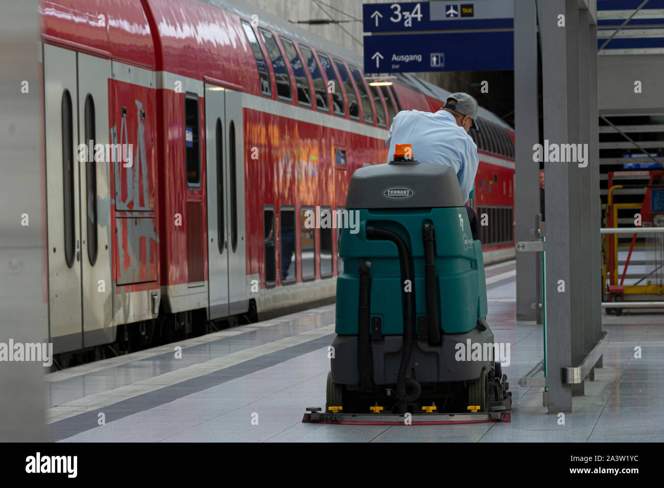 Germany Train station - a man cleaning Stock Photo - Alamy