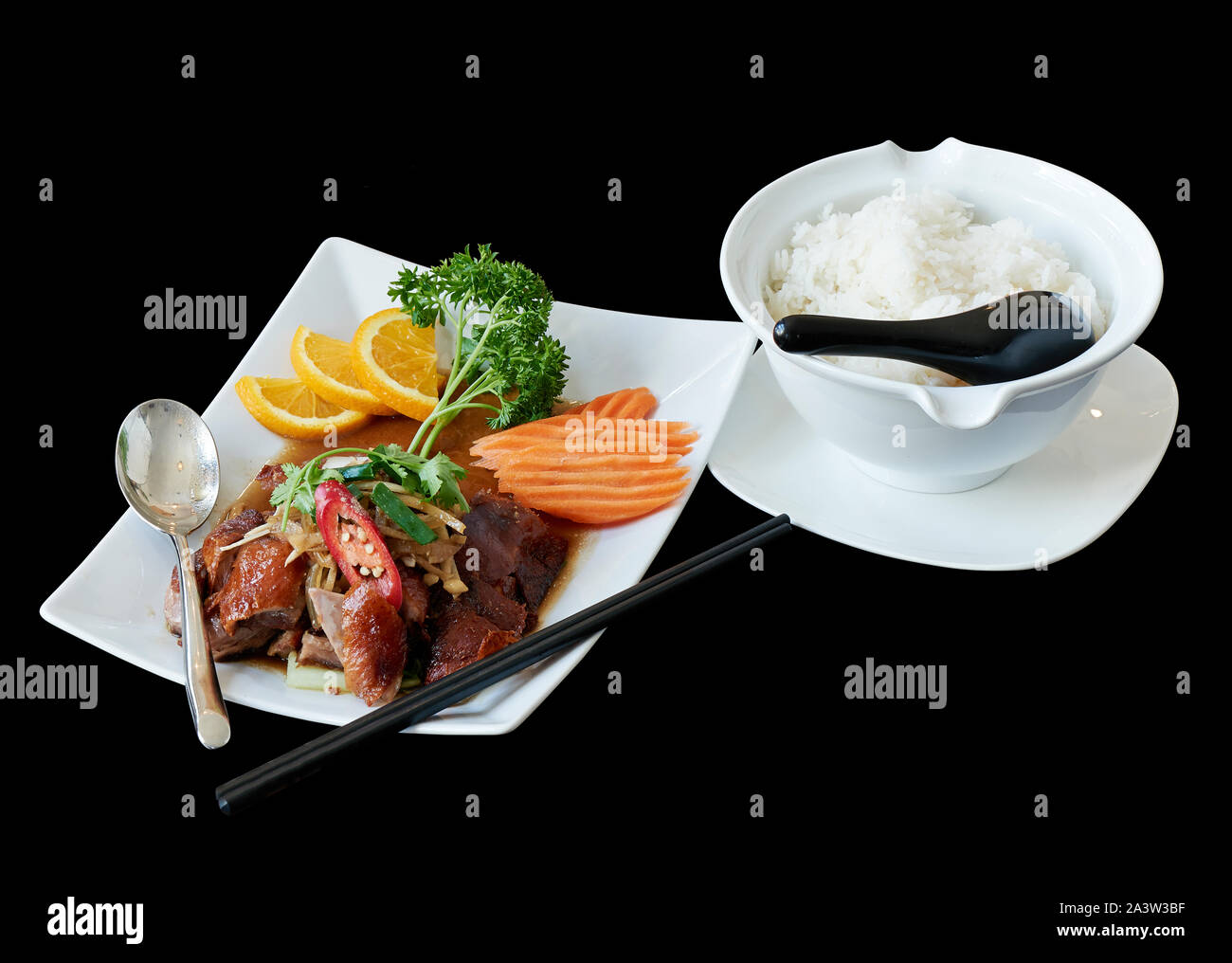Grilled peking duck on plate with white rice on black background Stock ...