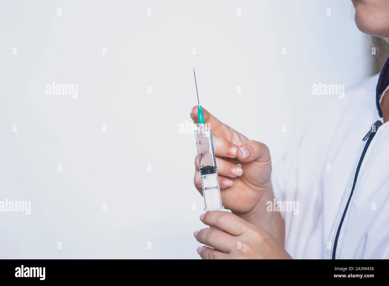 Female doctor hands with syringe, doctor preparing injection medicine ...