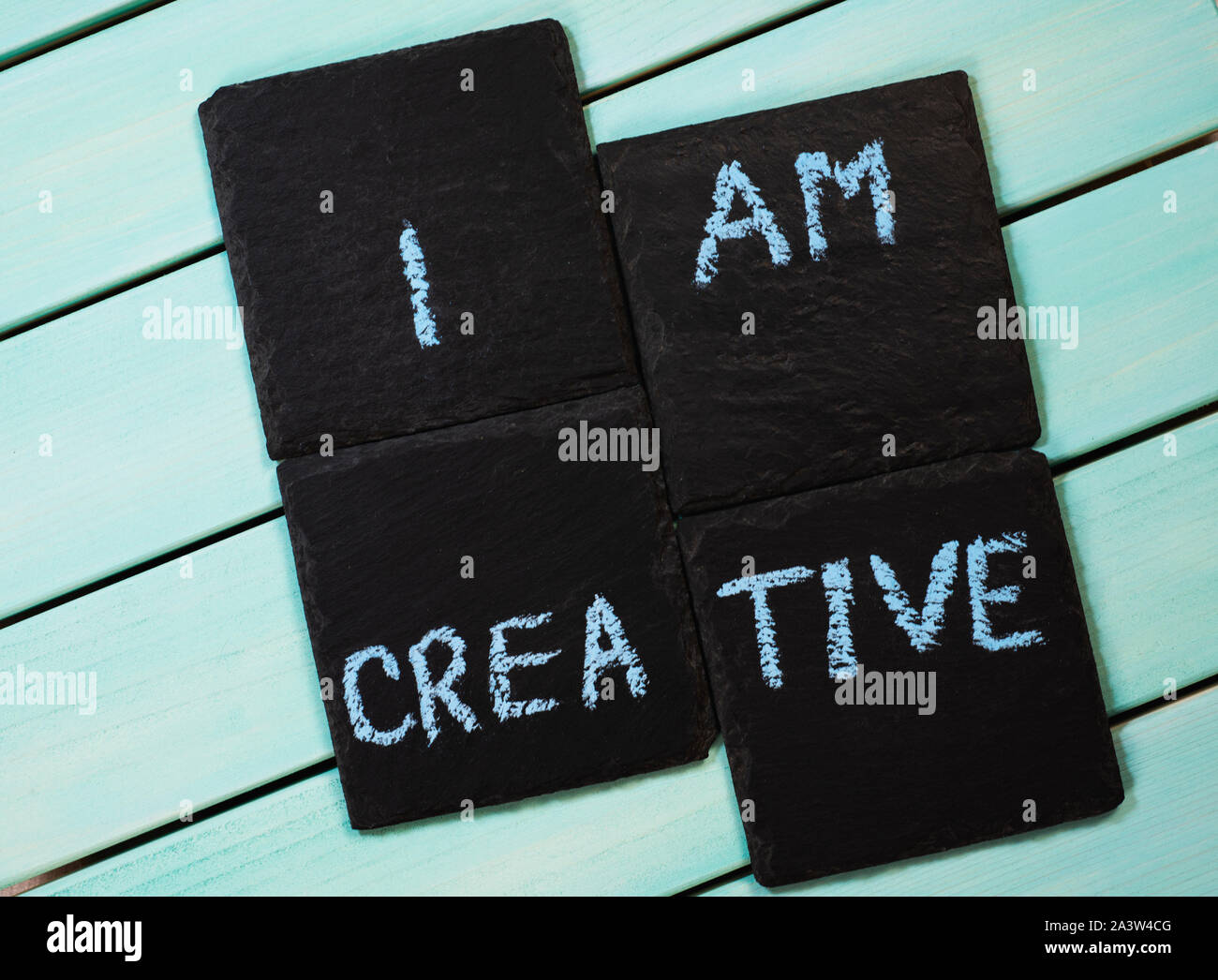 Handwitten words i am creative on blue wooden board background ...
