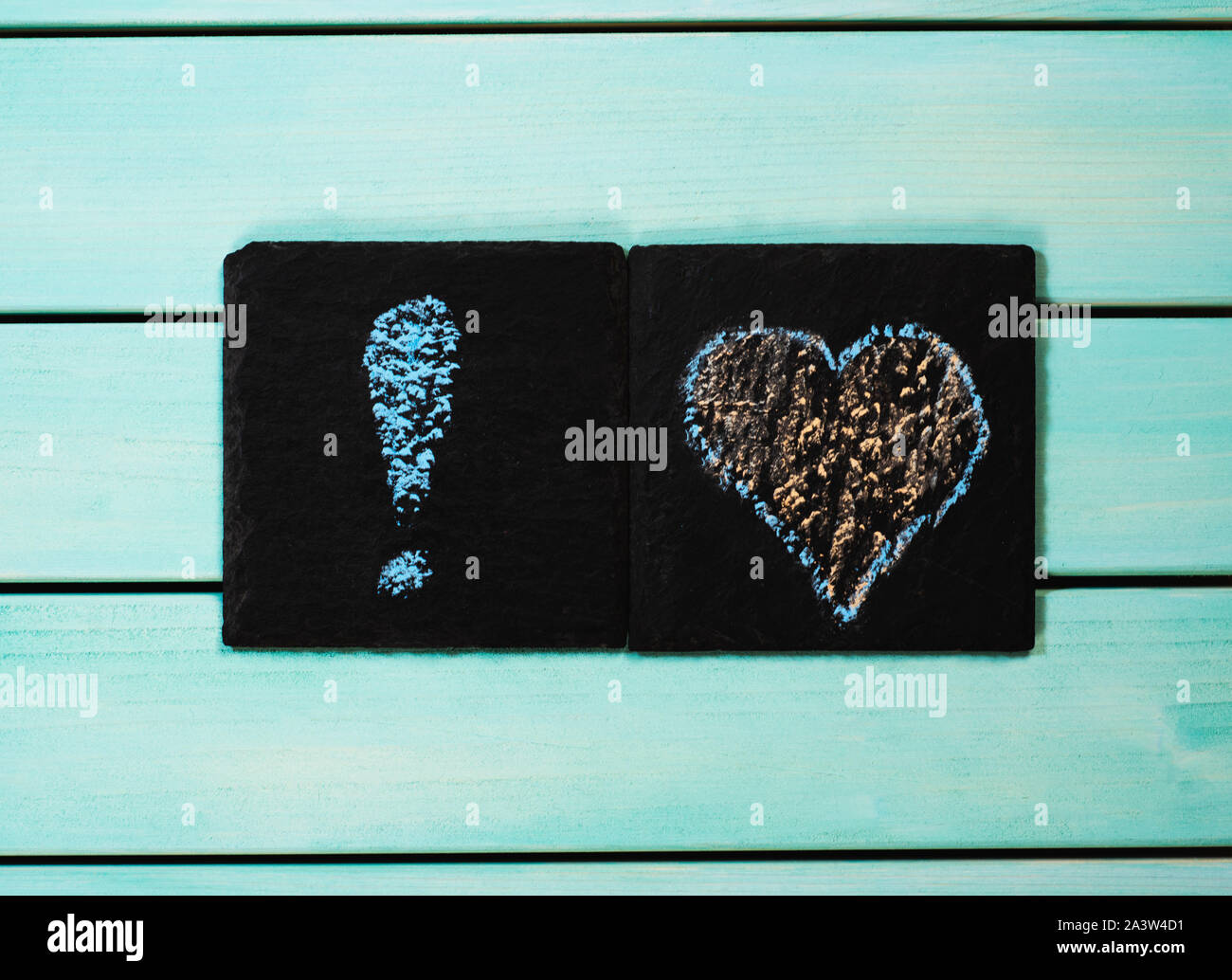 Heart and exclamation mark drawn with chalk, blue wooden background ...