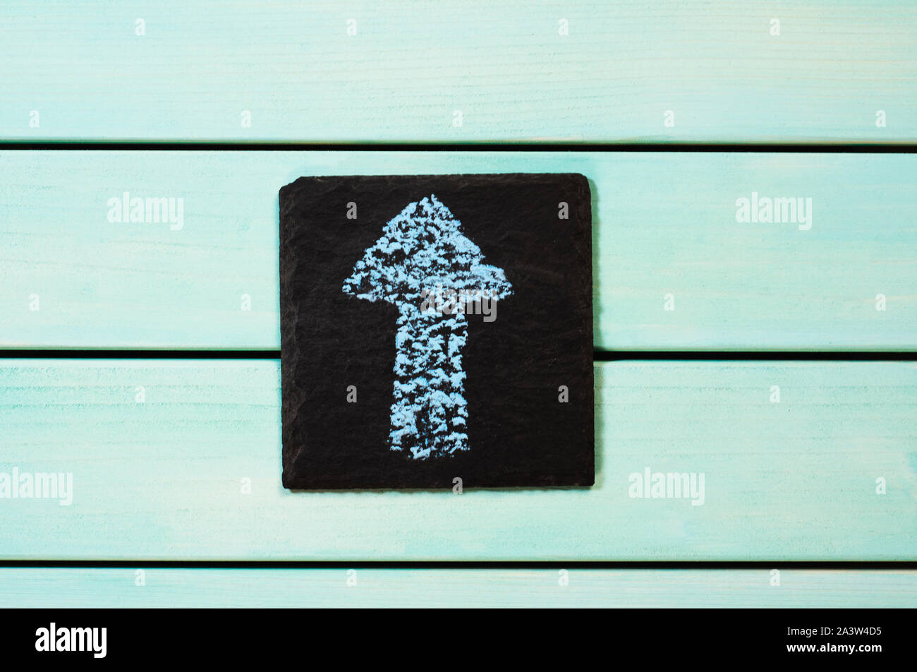 Arrow symbol on blue wooden background, direction and decision concept ...