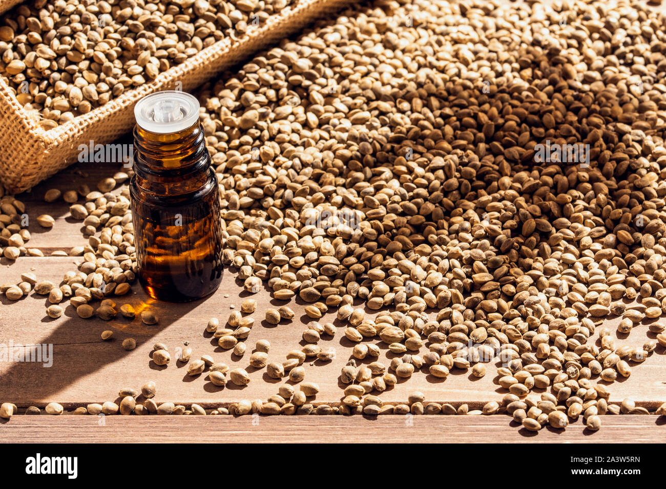 Bottle of medicinal hemp oil on wooden table with hemp seeds Stock ...