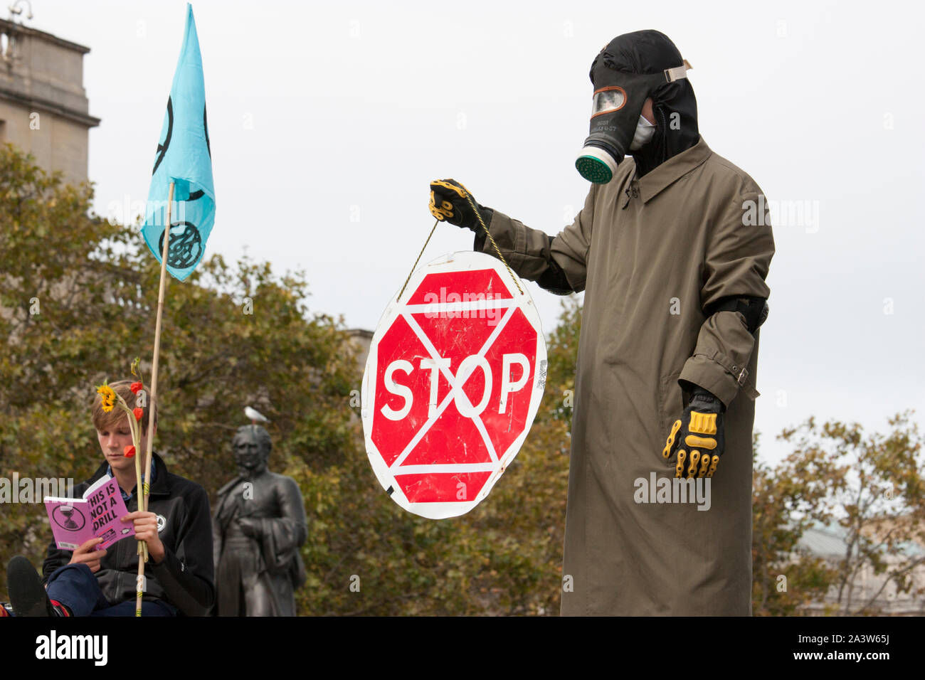 Extinction Rebellion protests London, protester with gas mask and stop ...