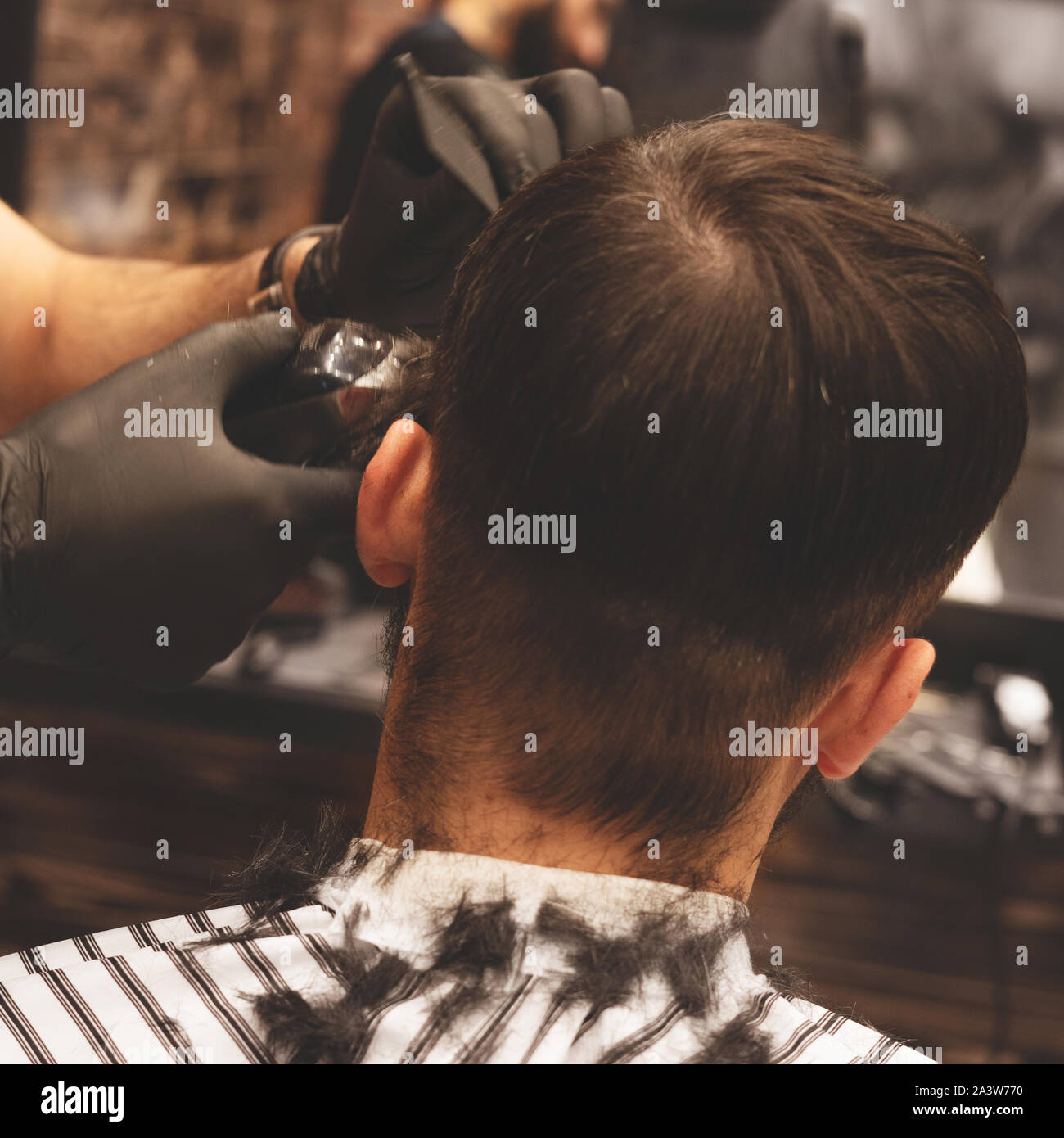 Haircut head in barbershop. Barber cuts the hair on the head of the ...