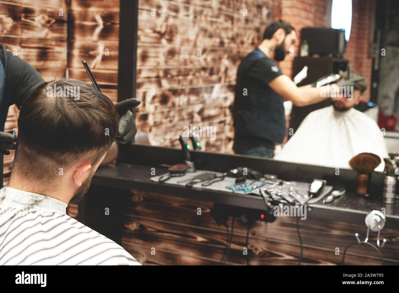 Haircut head in barbershop. Barber cuts the hair on the head of the ...