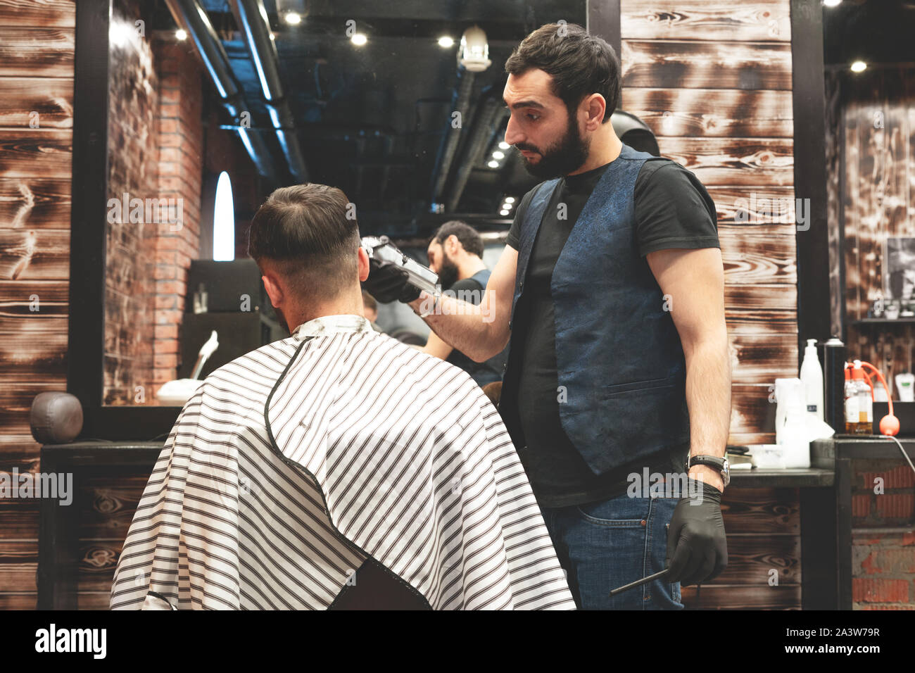 Haircut head in barbershop. Barber cuts the hair on the head of the ...
