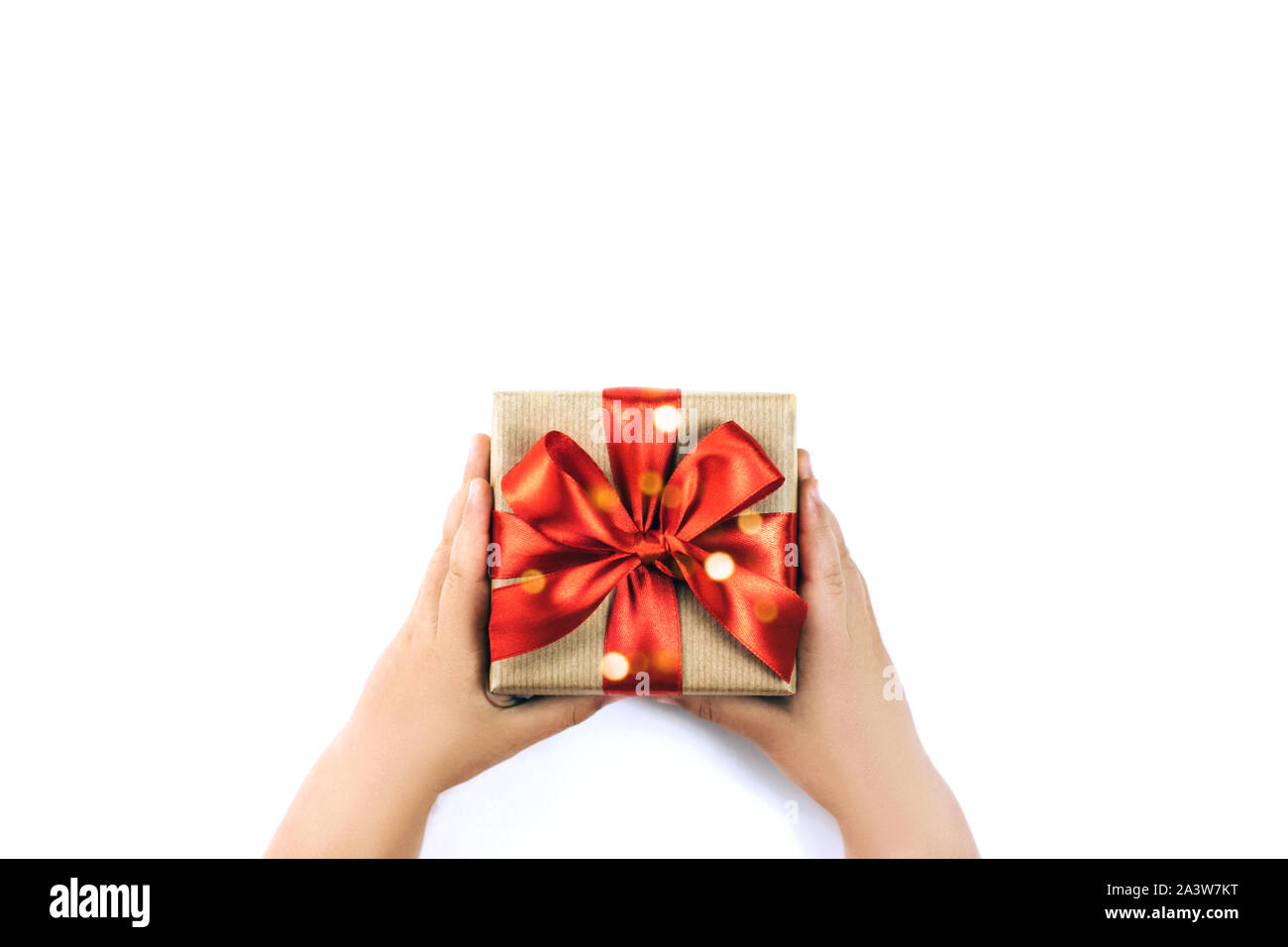 Child's hands holding gift box isolated on white background. Flat lay ...