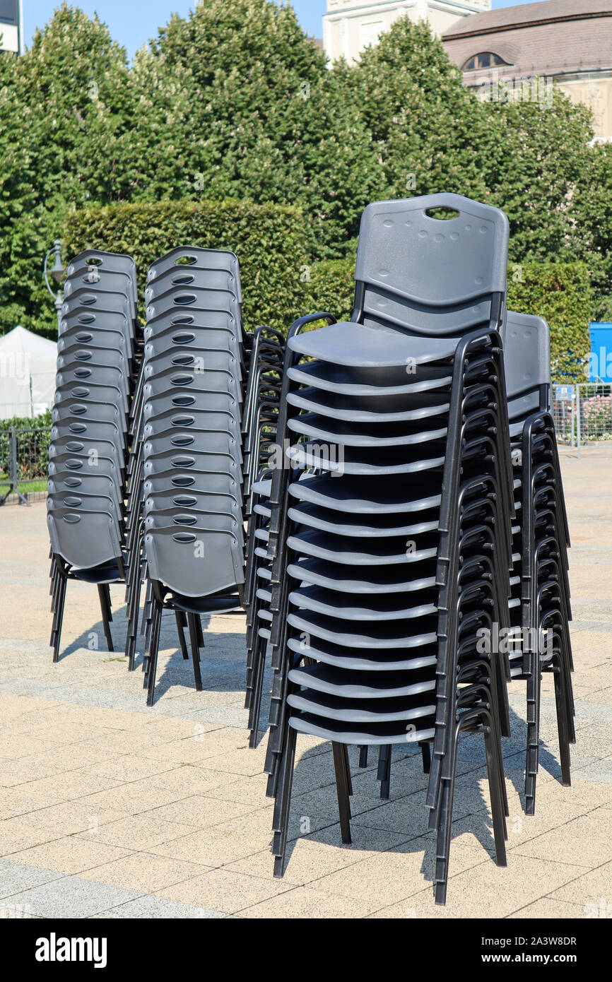 Pile of stackable portable chairs Stock Photo - Alamy