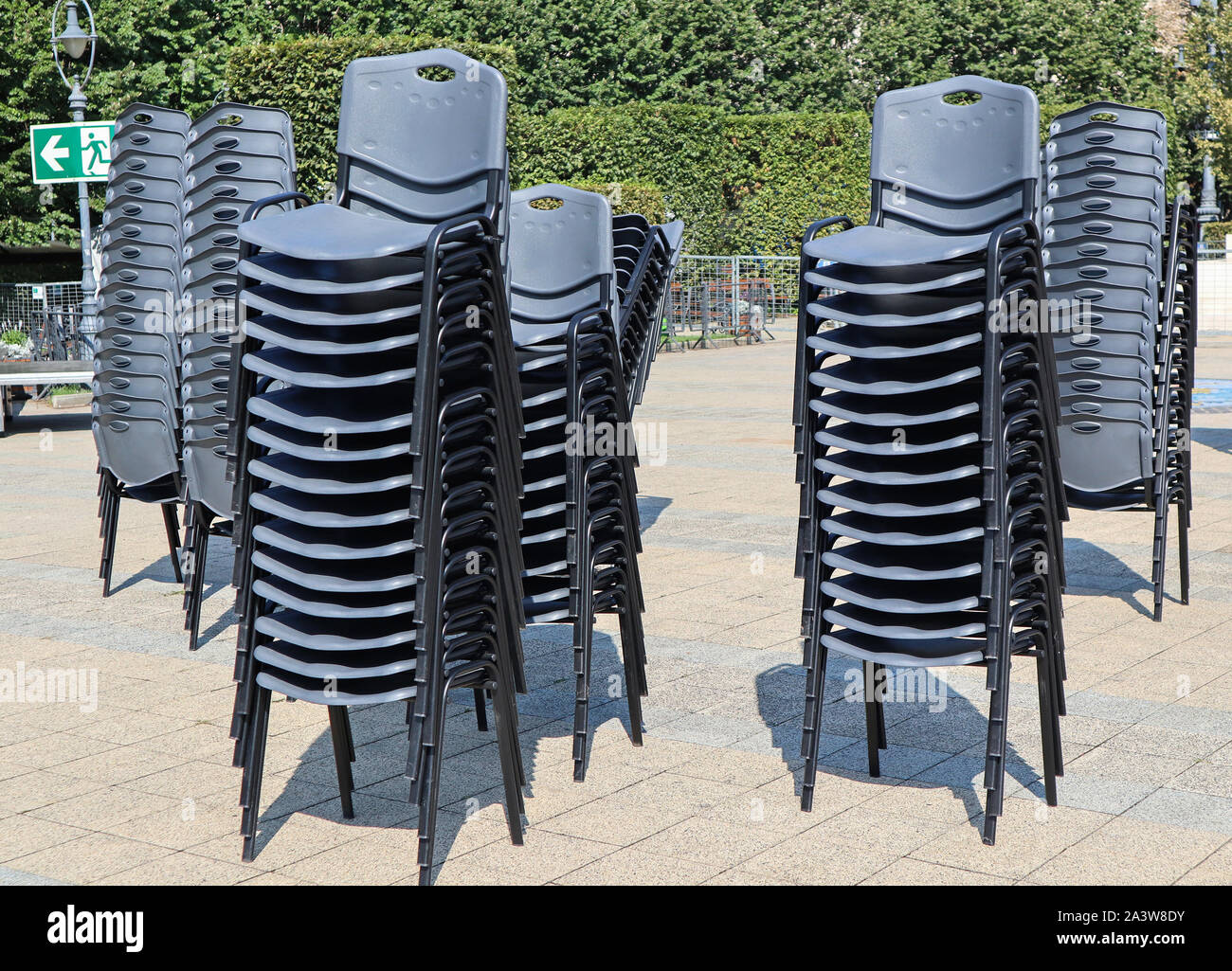 Pile of stackable portable chairs Stock Photo - Alamy