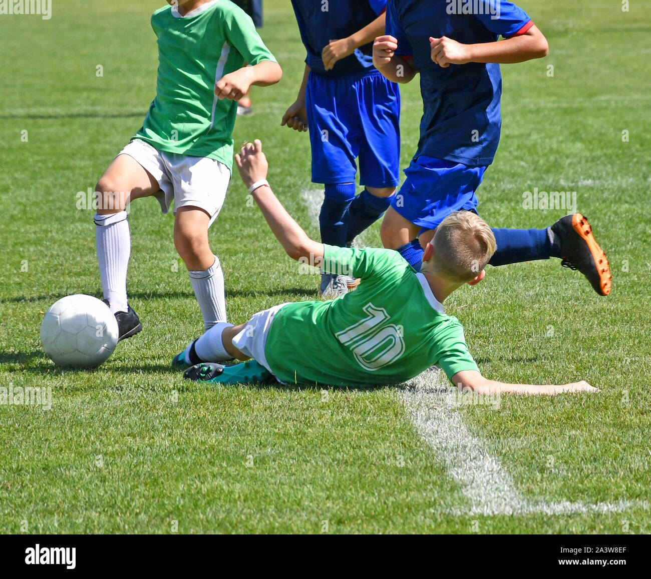 Kids are playing soccer in summer Stock Photo - Alamy