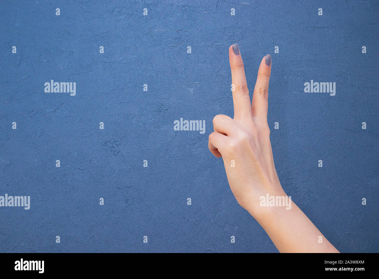 Women holding hand sign on isolated background Stock Photo - Alamy