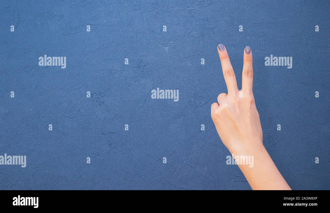 Women holding hand sign on isolated background Stock Photo - Alamy