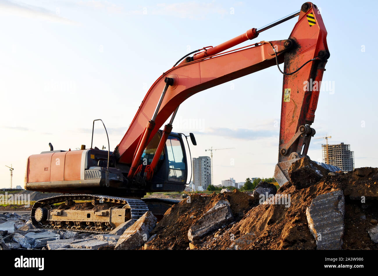 Large tracked excavator works in a gravel pit. Loading of stone and ...