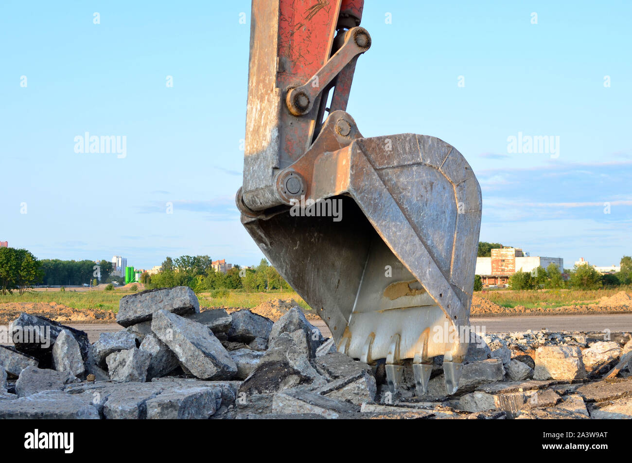 Excavator working in a construction site. Large metal iron ladle ...