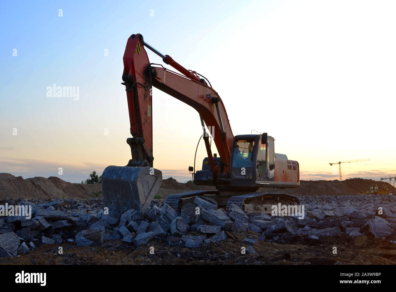 Large tracked excavator works in a gravel pit. Loading of stone and ...