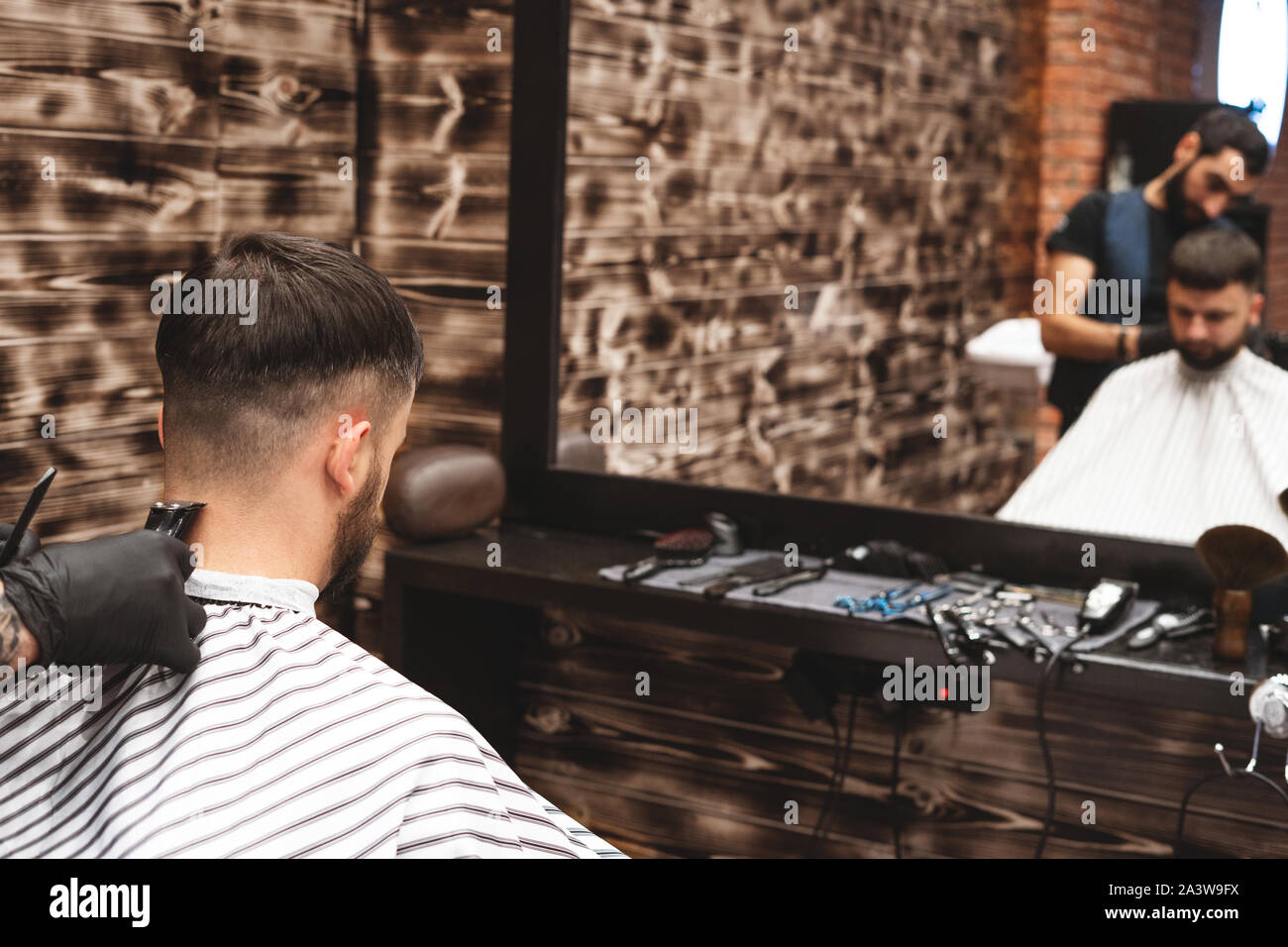 Haircut head in barbershop. Barber cuts the hair on the head of the ...