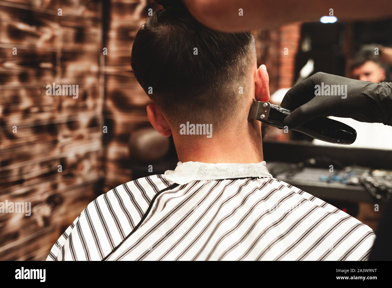 Haircut head in barbershop. Barber cuts the hair on the head of the ...
