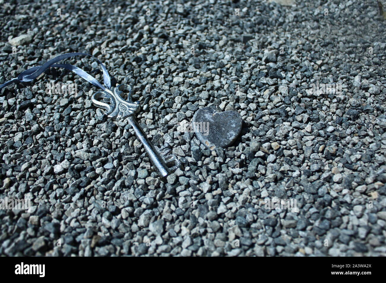 The picture shows a key and a heart of stone Stock Photo - Alamy